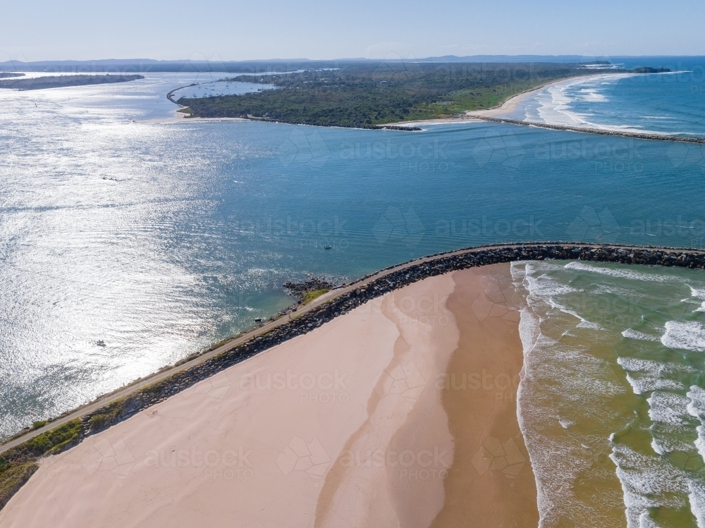 Image of Aerial view of a wide river flowing out to sea between rocky ...