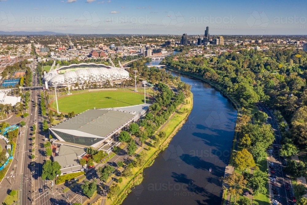 Image of Aerial view of a wide river winding through a city with ...