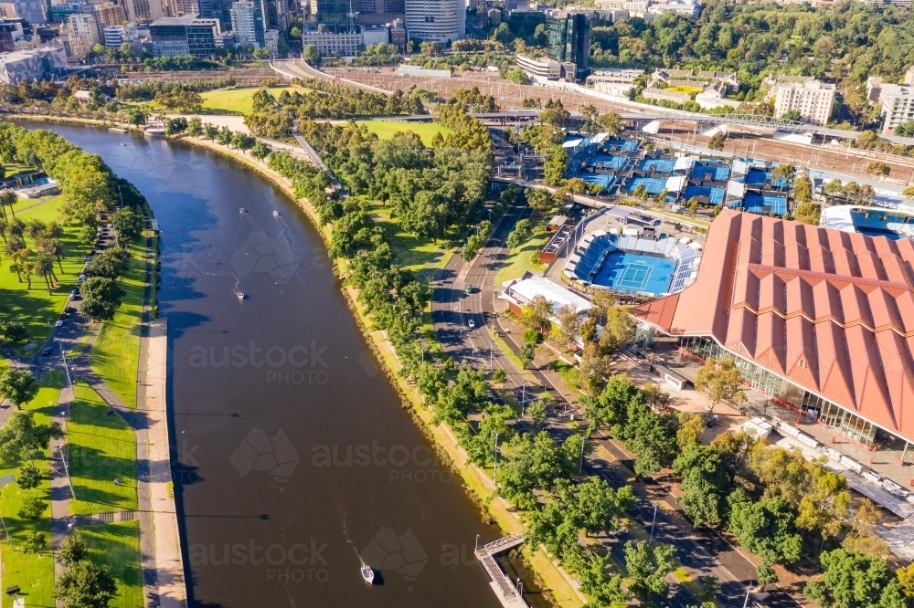 Image of Aerial view of a wide river winding through a city with ...