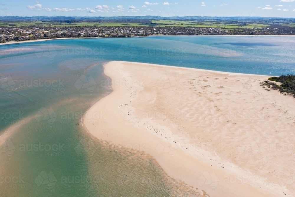 Image of Aerial view of a wide sandy beach jutting out into a coastal ...
