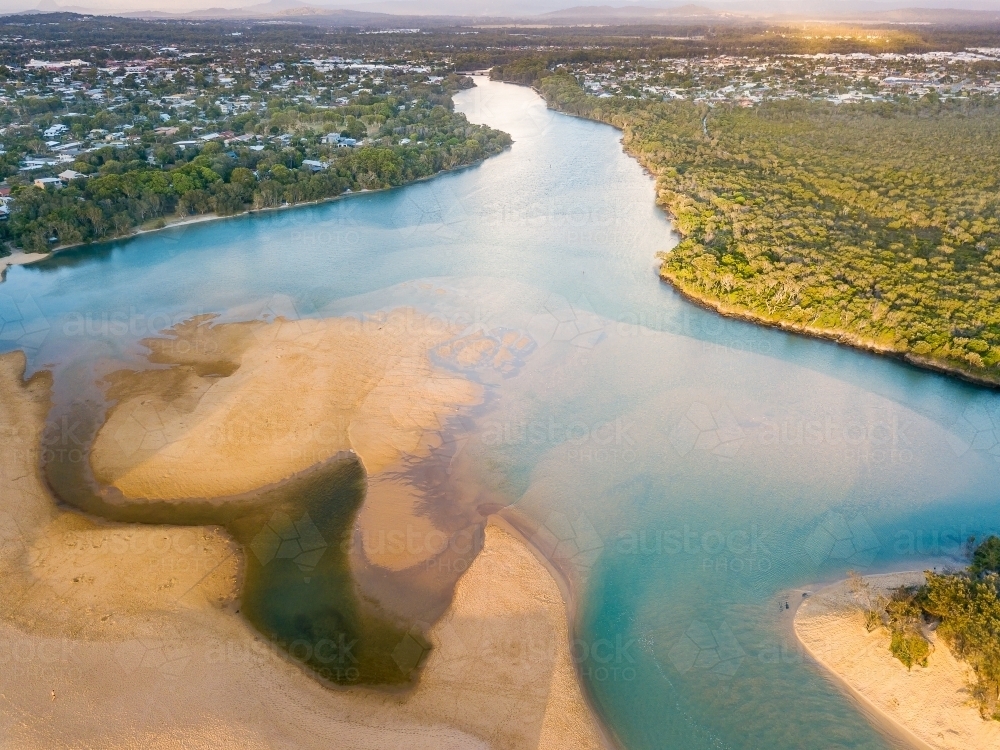 Image of Aerial view of a widening river with sandbars - Austockphoto