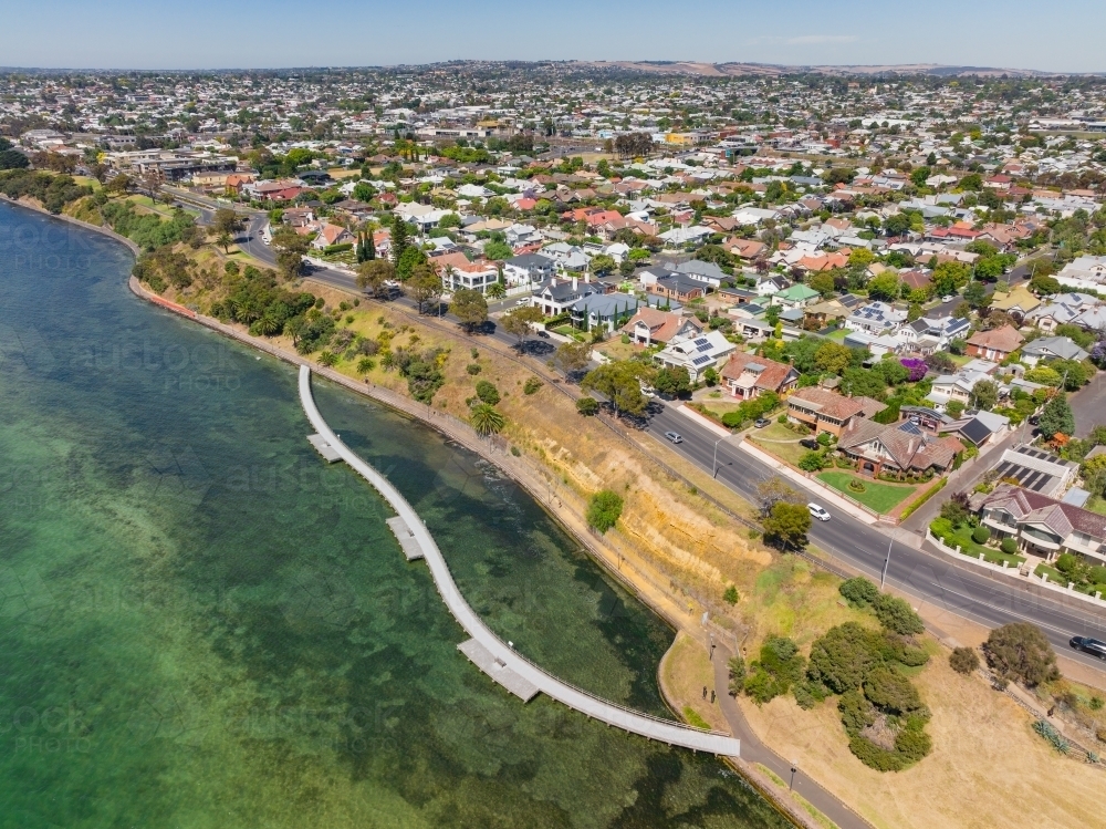 Image of Aerial view of a winding boardwalk alongside coastal parkland ...