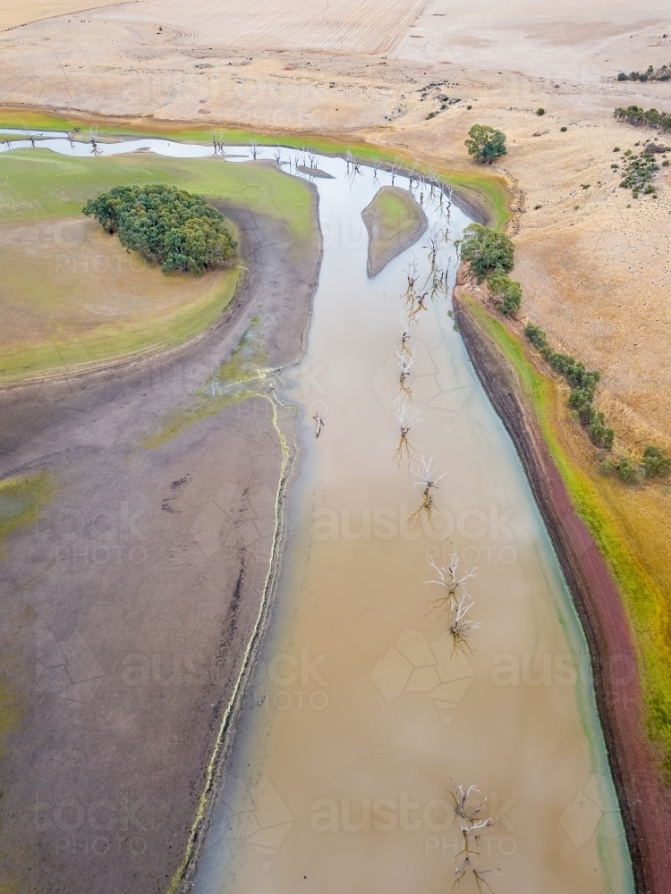 Image of Aerial view of a winding river with through farmland ...