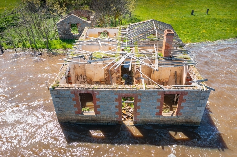 Image of Aerial view of an abandoned historic farm house with no roof ...