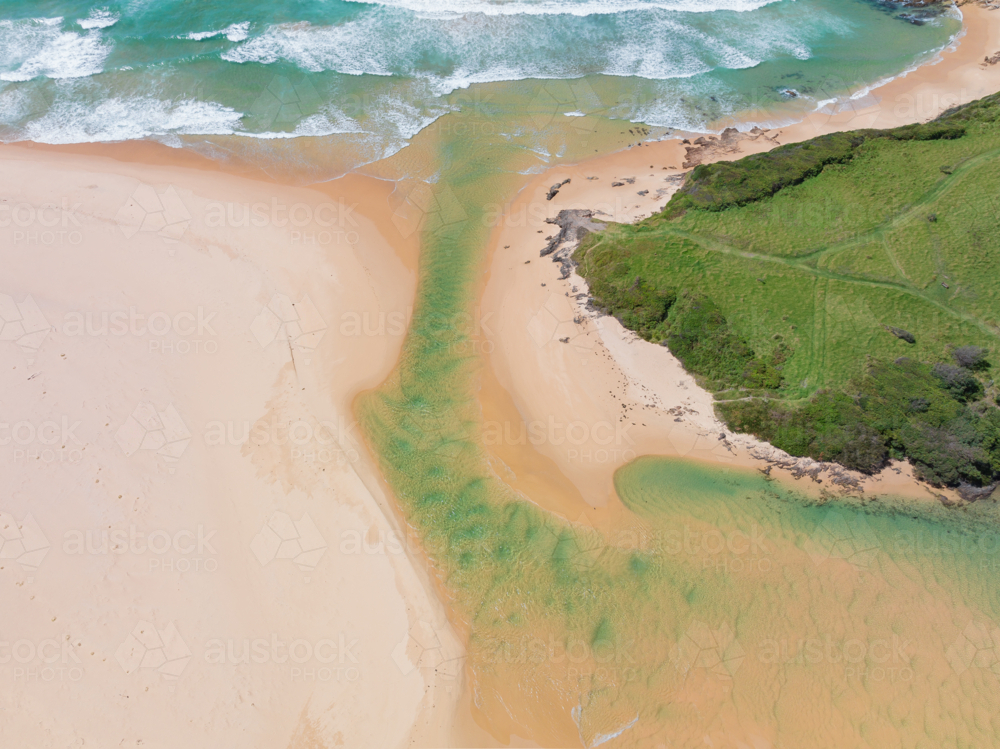 Image of Aerial view of an inland lake flowing around a coastal ...