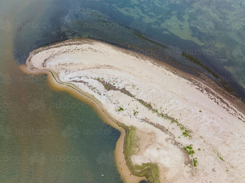 Image of Aerial view of an unusually shaped coastal sand bar - Austockphoto