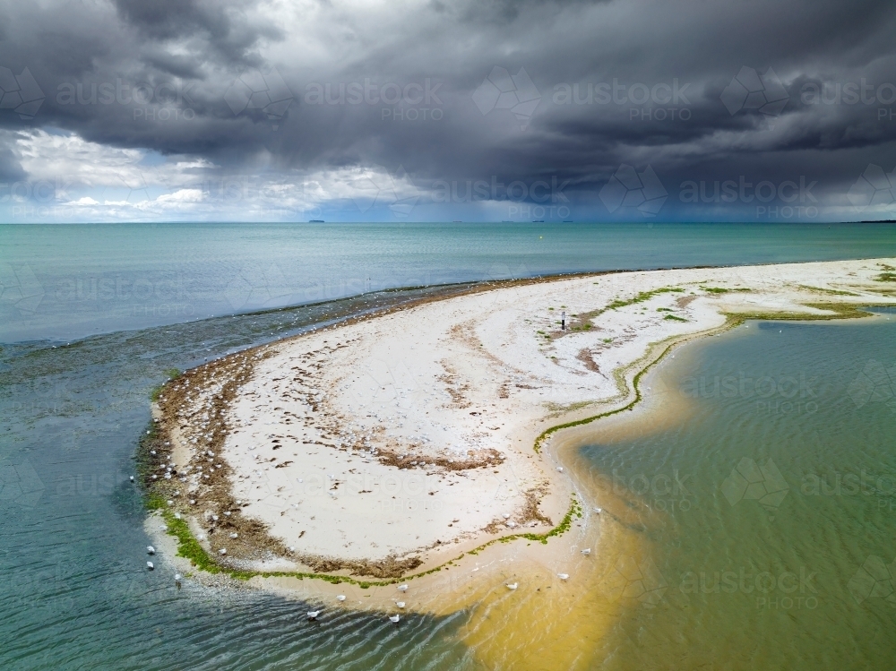 Image of Aerial view of an unusually shaped coastal sand bar under a ...