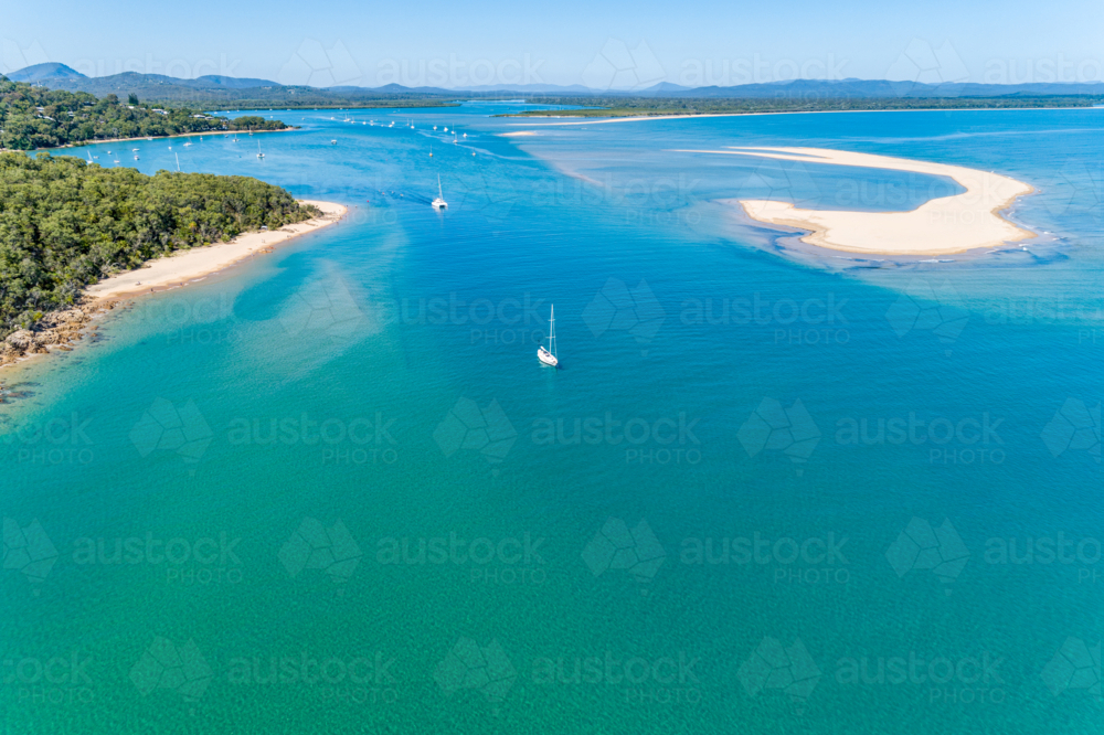 Image of Aerial view of boats anchored in shallow estuary, Seventeen ...