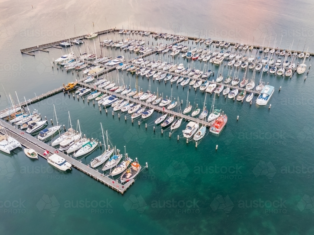 Image of Aerial view of boats and yachts moored at a marina - Austockphoto
