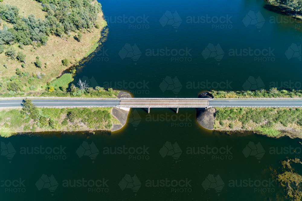 Image of Aerial view of bridge and road crossing a lake. - Austockphoto