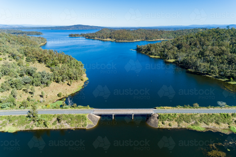 Image of Aerial view of bridge and road crossing a lake. - Austockphoto