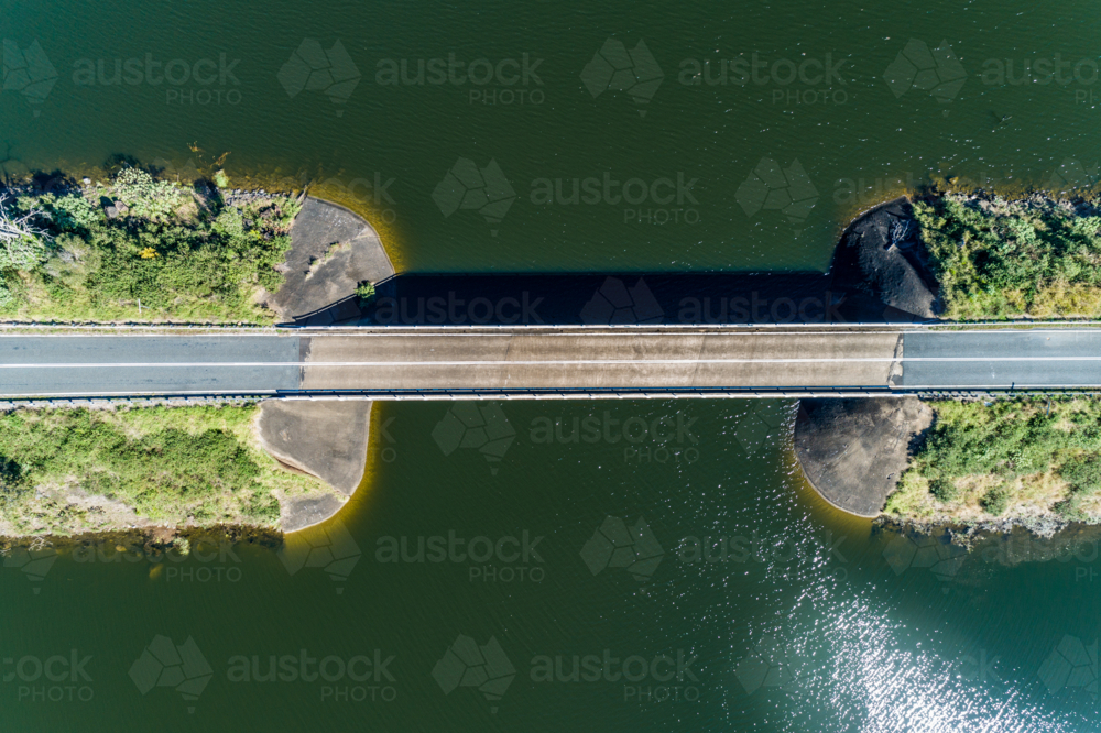 Image of Aerial view of bridge and road crossing a lake. - Austockphoto