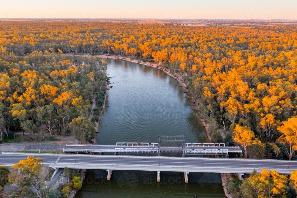 Image of Aerial view of bridges crossing a wide river running through ...