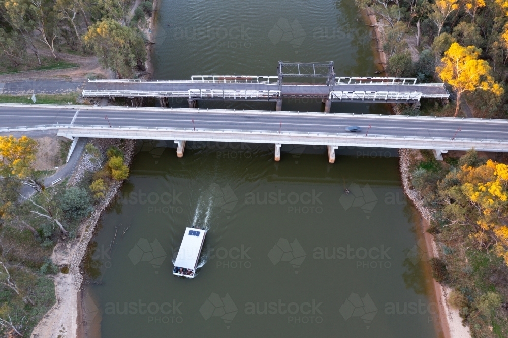 Image of Aerial view of bridges crossing a wide river with a house ...
