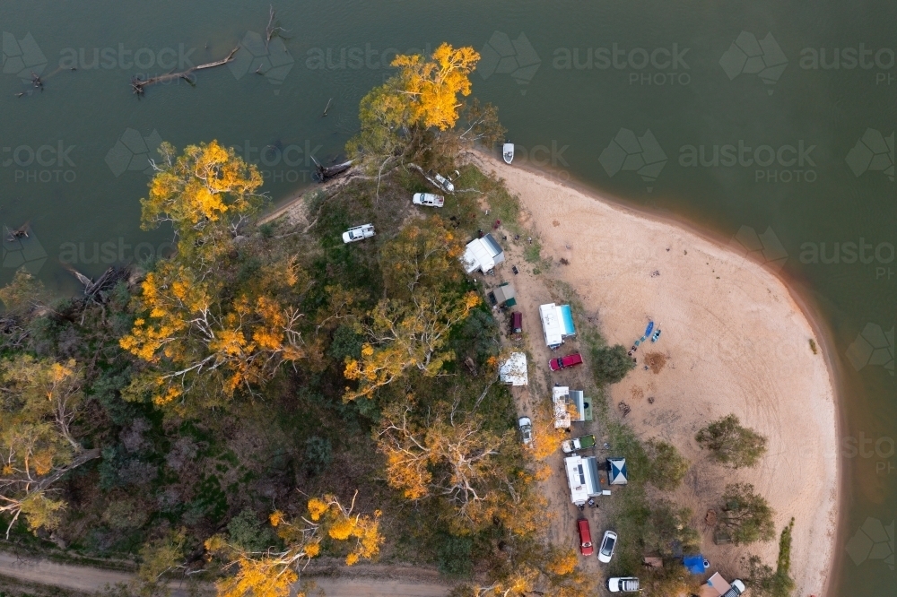 Image of Aerial view of caravans camped under gum trees on the banks of ...