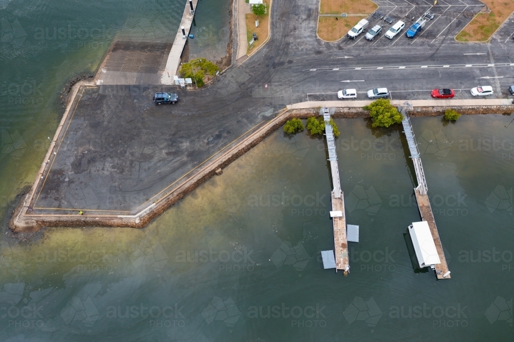 Image of Aerial view of cars parked at a marina carpark with jettys and ...