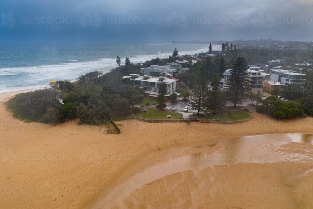 Image of Aerial view of coastal real estate and a sandy beach during a ...