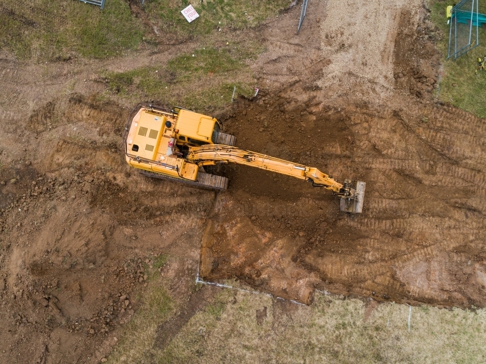 Image of Aerial view of digger on house build construction site ...