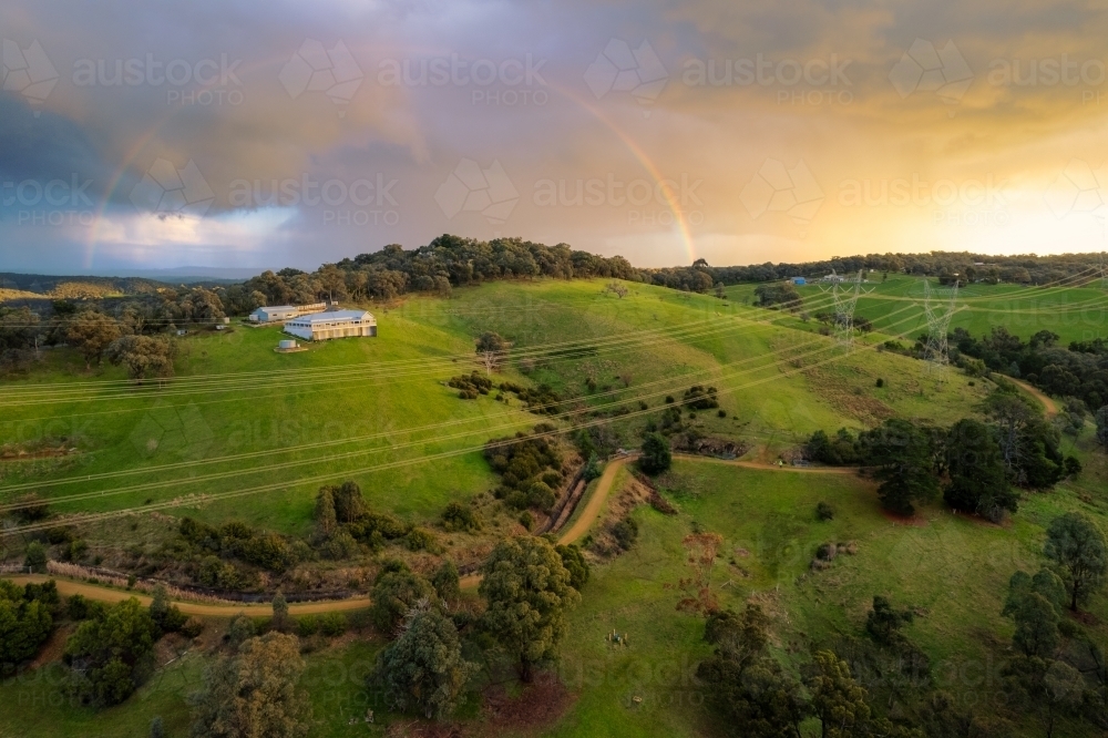 Image of Aerial View of Distant Farm House and Powerlines - Austockphoto