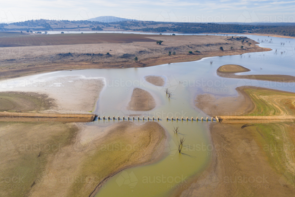 Image of Aerial view of disused bridge pylons crossing mud flats and ...