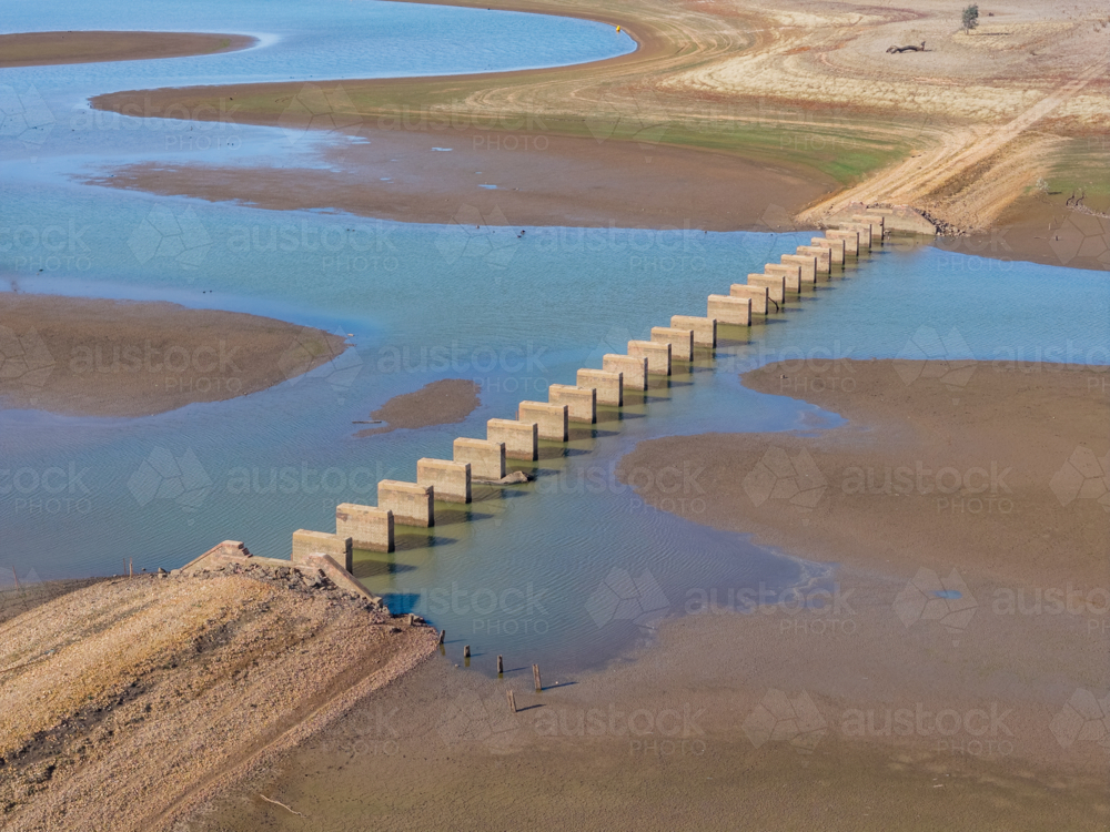 Image of Aerial view of disused bridge pylons crossing mud flats and ...