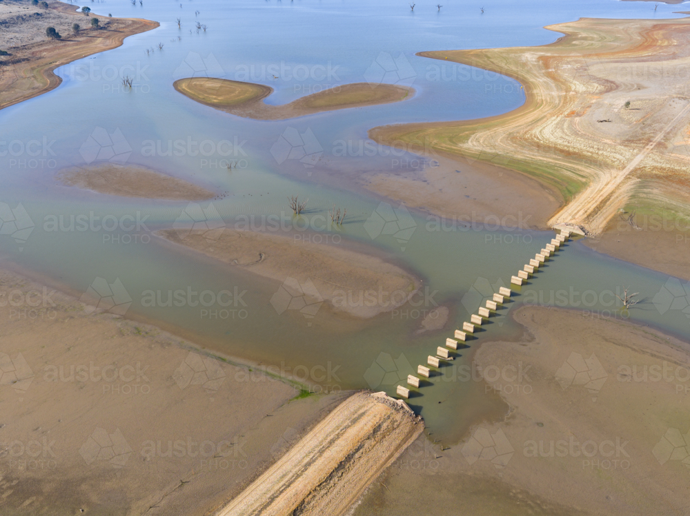 Image of Aerial view of disused bridge pylons crossing mud flats and ...