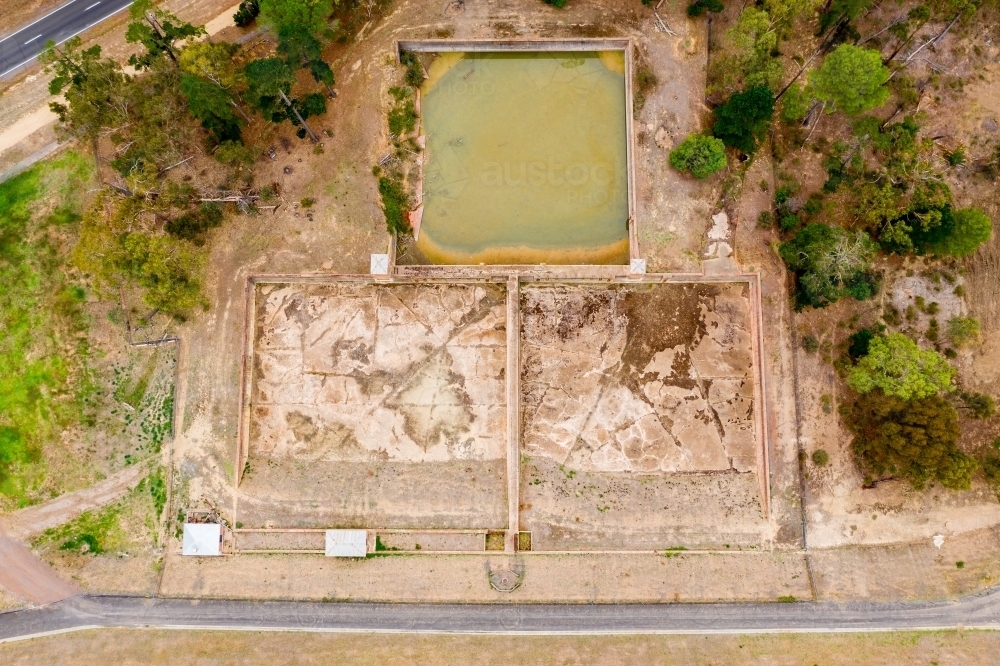 Image of Aerial view of disused settling ponds with muddy bottoms ...