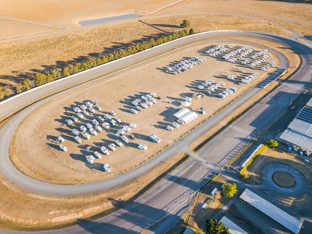 Image of Aerial view of dozens of motor homes parked at a racetrack ...