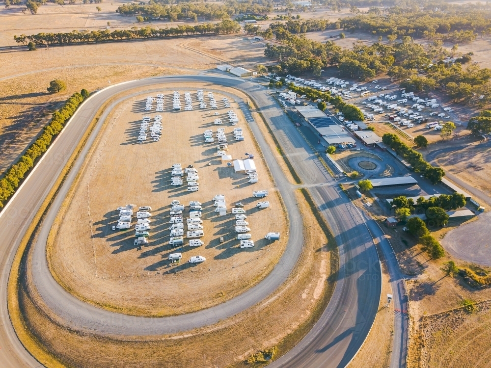 Image of Aerial view of dozens of motorhomes parked at a racetrack ...