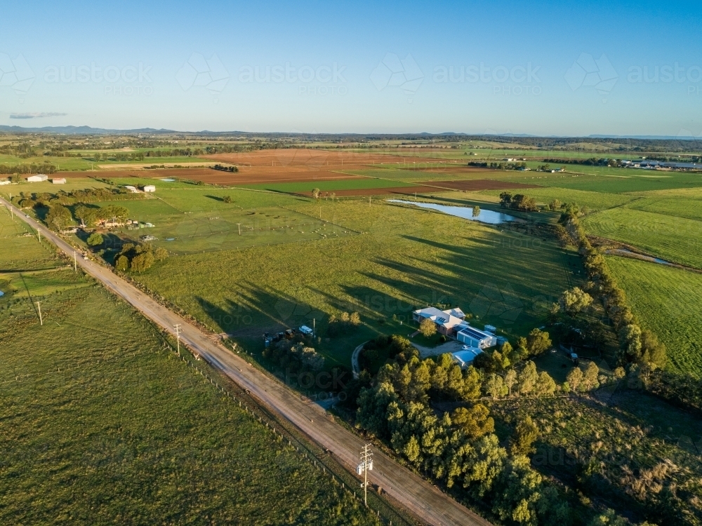 Image of Aerial view of farm house in green agricultural landscape ...