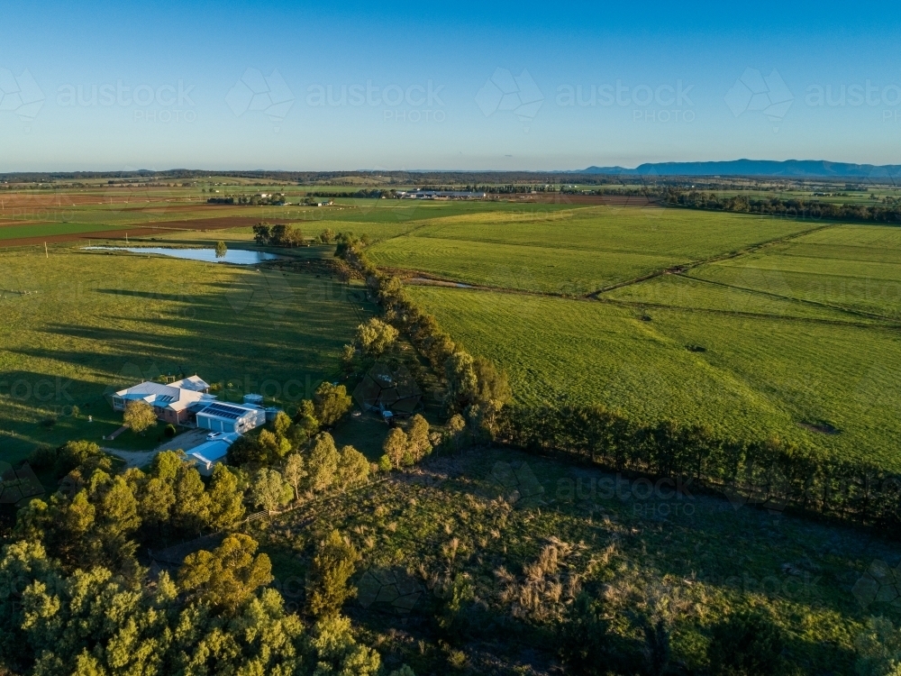Image of Aerial view of farm house in green agricultural landscape ...