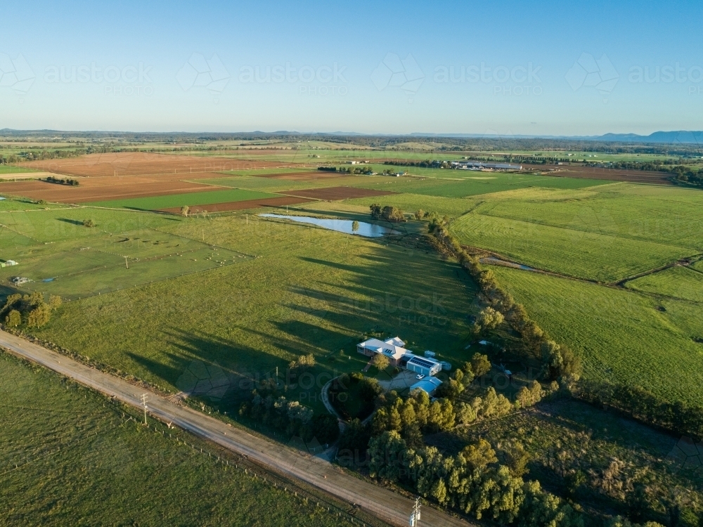 Image of Aerial view of farm house in green agricultural landscape ...