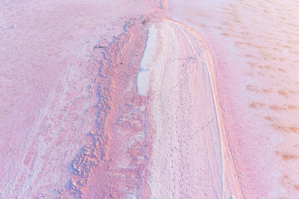 Image of Aerial view of fence line detail through a pink salt Lake ...