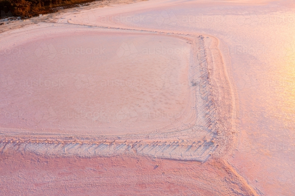 Image of Aerial view of fence line detail through a pink salt Lake ...