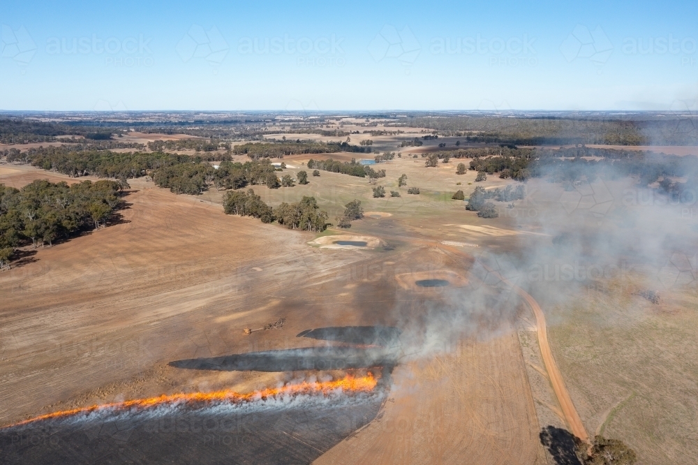 Image of aerial view of fire burning in stubble paddock on a farm ...