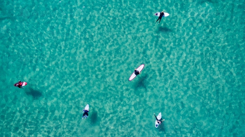 Image of Aerial view of five surfers - Austockphoto