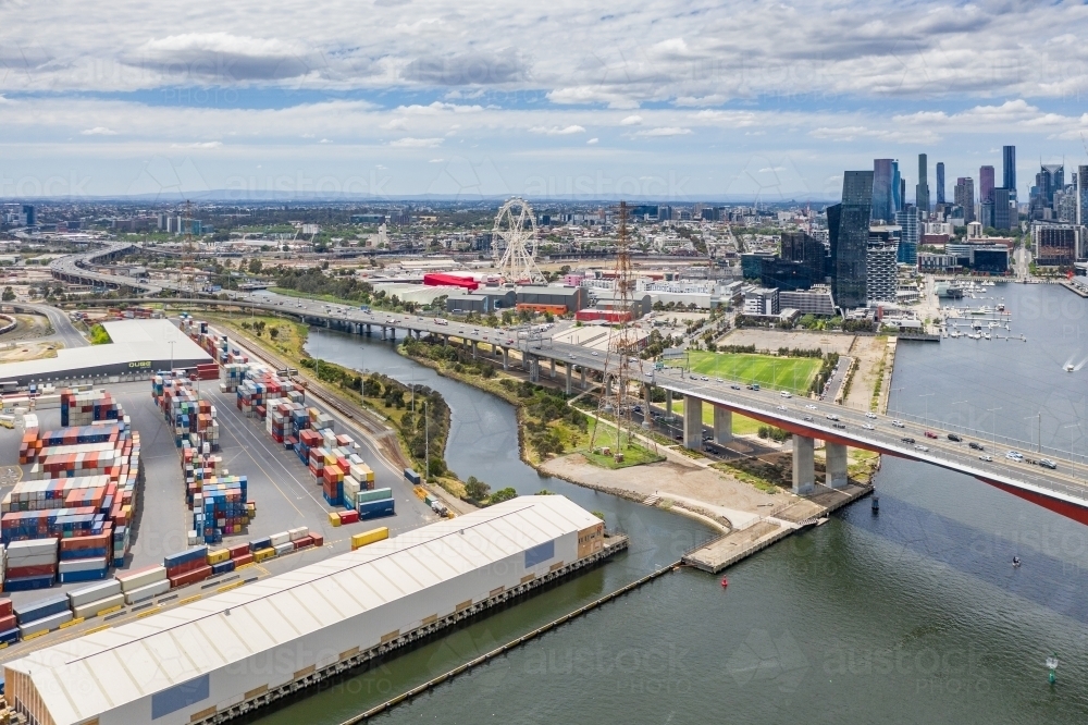Image of Aerial view of freeway ramp over river along side a yard ...
