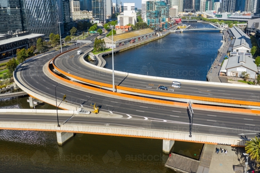 Image of Aerial view of freeway ramps crossing an inner city river ...