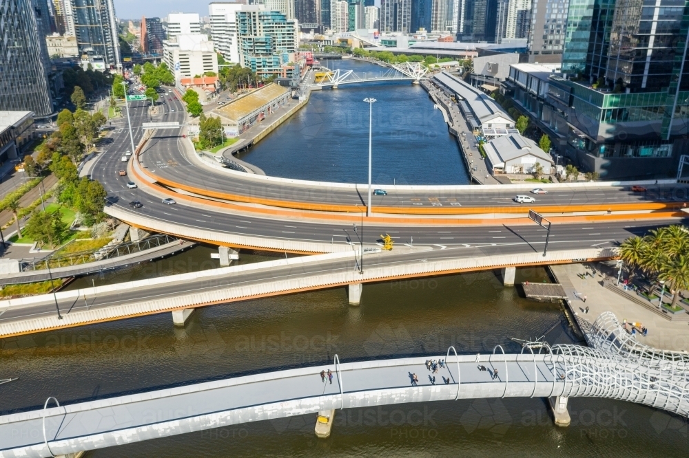 Image of Aerial view of freeway ramps crossing an inner city river ...