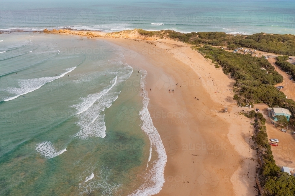 Image of Aerial view of gentle waves on a wide sandy beach inside a ...