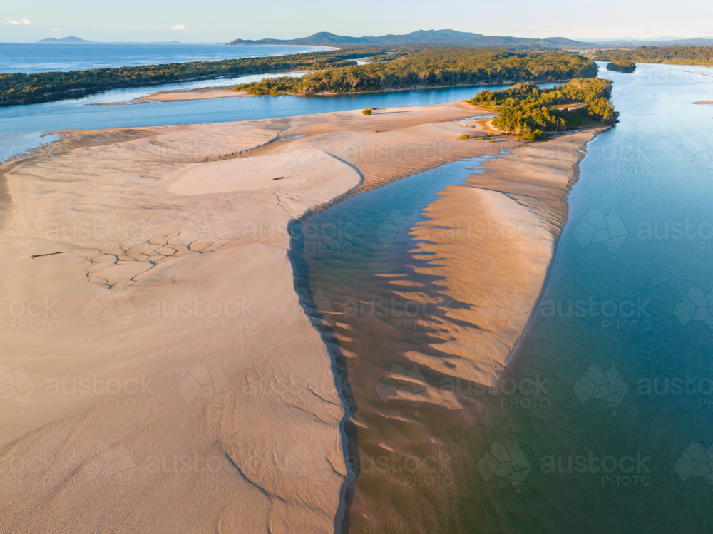Image of Aerial view of golden morning light on sand bars and water of ...