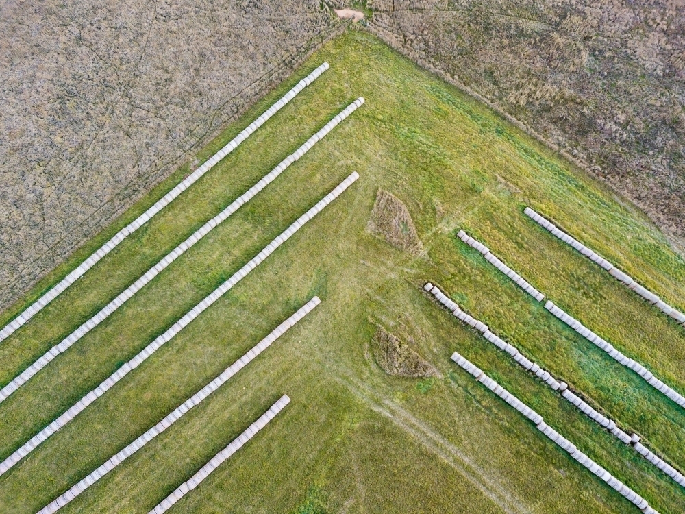 Image of Aerial view of hay bales in rows at the corner of a paddock ...
