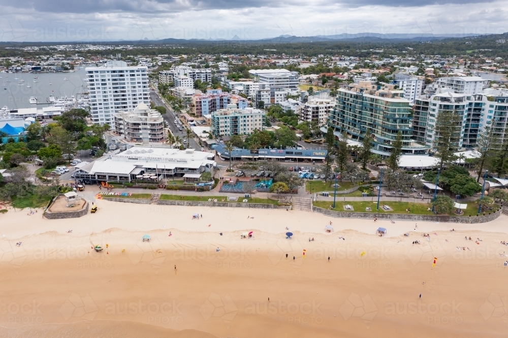 Image of Aerial view of high rise real estate behind a surf life saving ...
