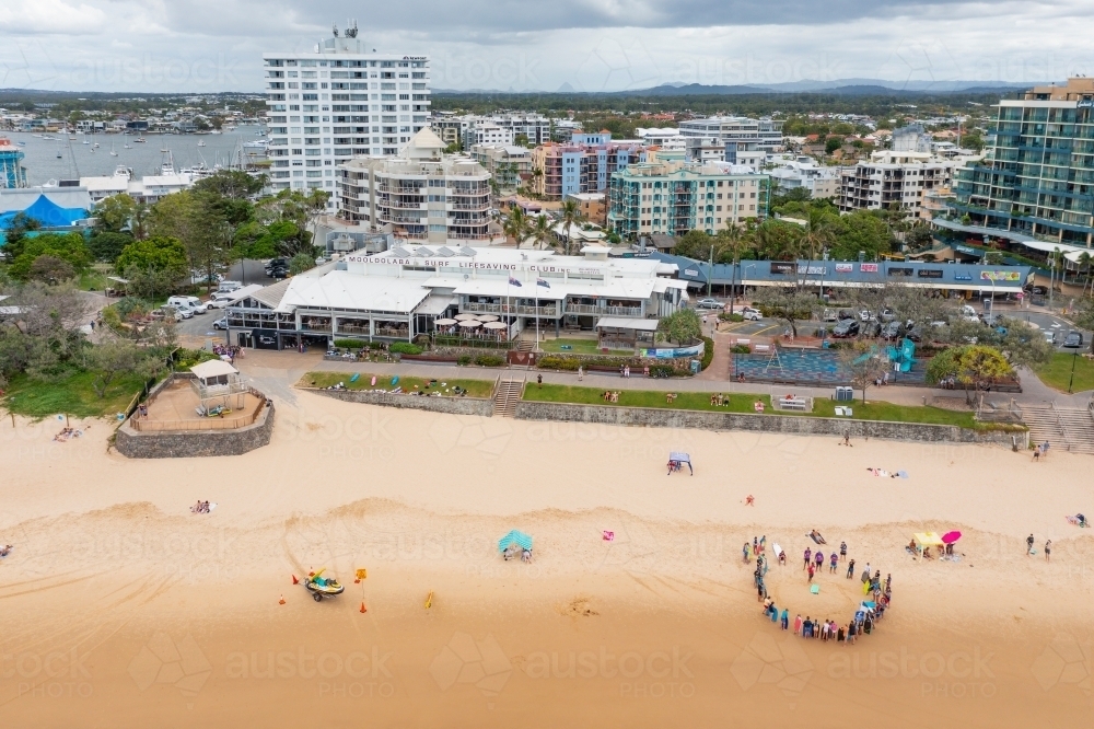 Image of Aerial view of high rise real estate behind a surf life saving ...