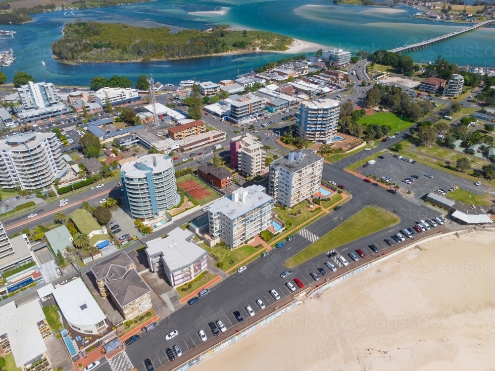 Image of Aerial view of high rise waterfront buildings behind a carpark ...