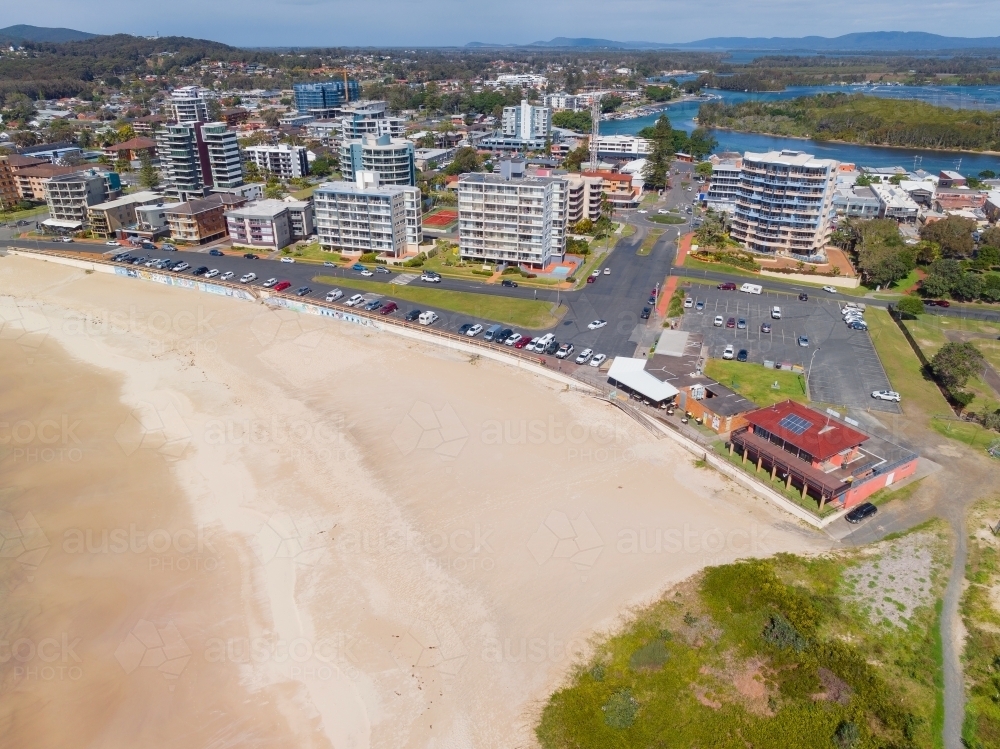 Image of Aerial view of high rise waterfront buildings behind a carpark ...