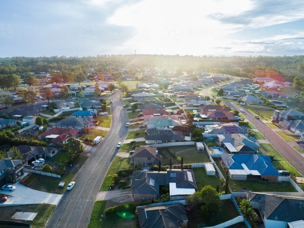 Image of Aerial view of houses and driveways along neighbourhood street ...