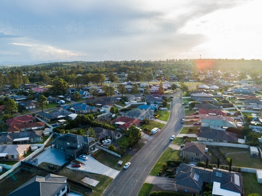 Image of Aerial view of houses and driveways along neighbourhood street ...