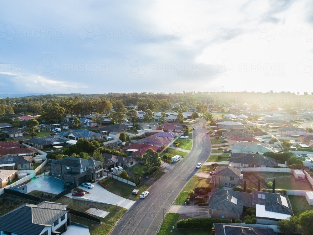 Image of Aerial view of houses and driveways along neighbourhood street ...