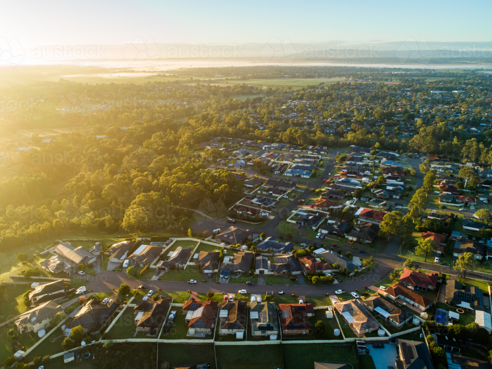 Image of Aerial view of houses in Singleton with golden sunrise haze ...